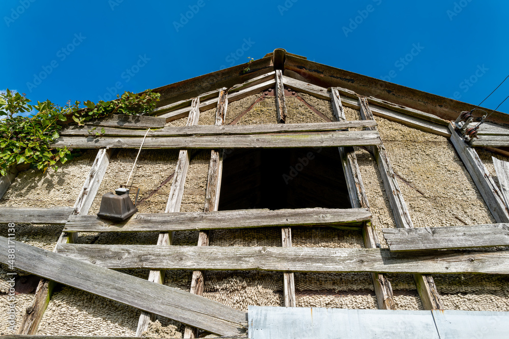 Vertical of a derelict farm building showing the poor state of repair ...
