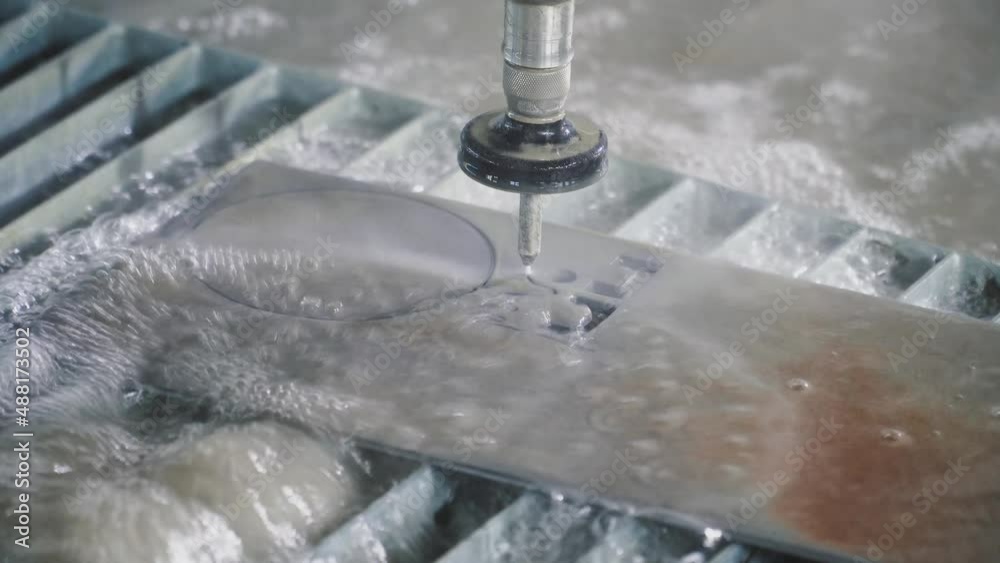Waterjet metal cutting. Hydroabrasive high pressure CNC machine is ...