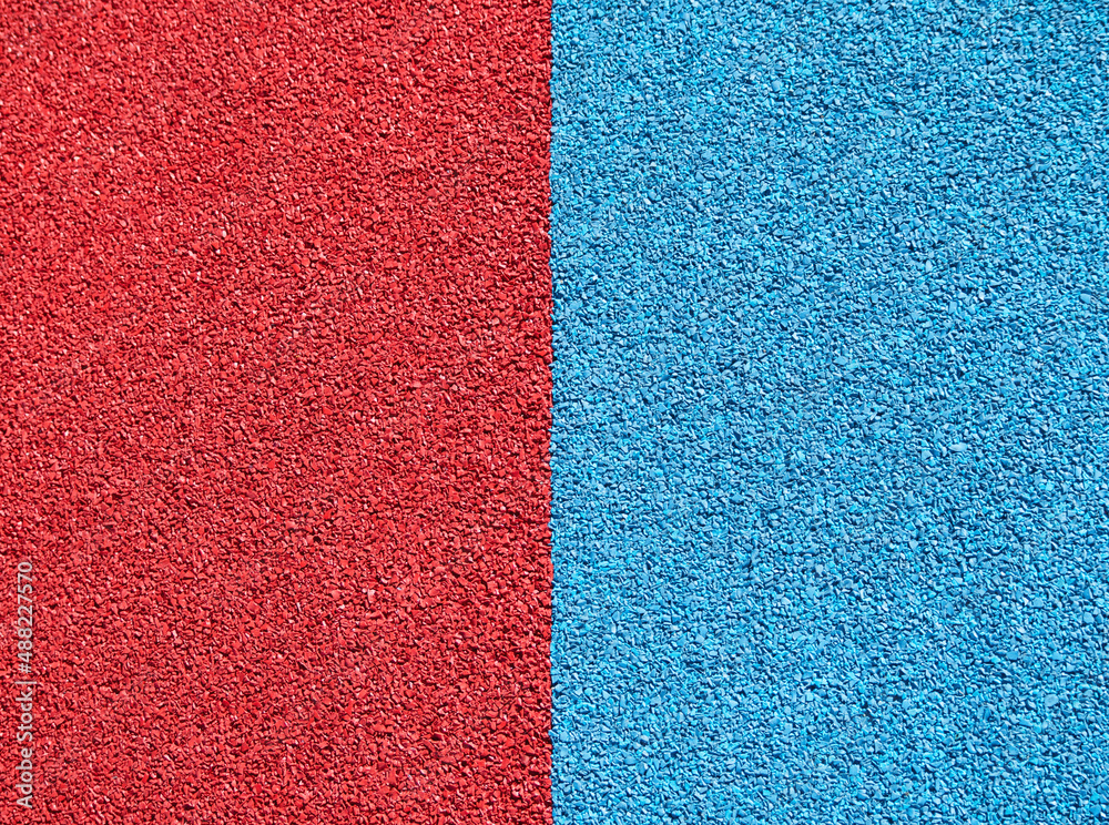Top view of sports ground or running track texture with red and blue ...