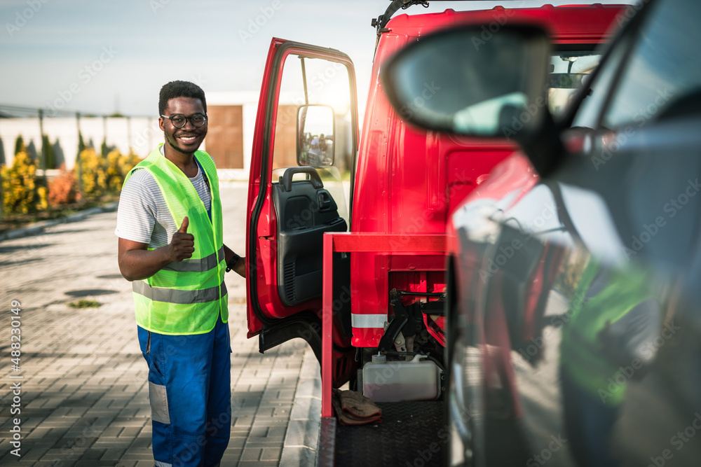 Young handsome African American man working in towing service and ...