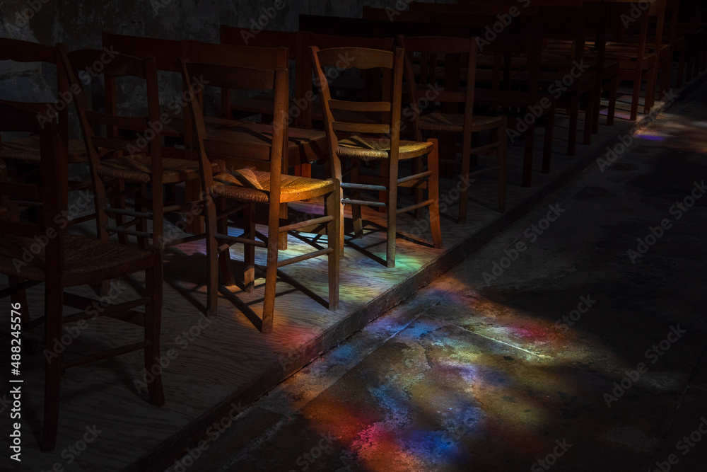 Sunlight filtered through the stained glass window reflected on the ...