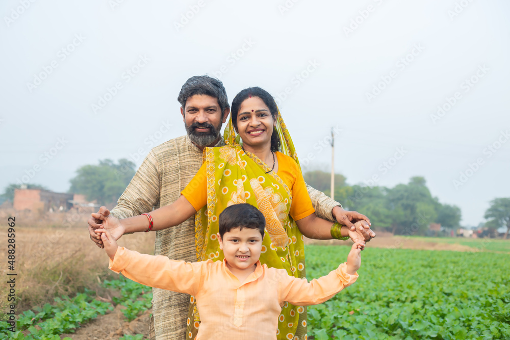 Portrait happy traditional Indian family at agricultural field, Smiling ...