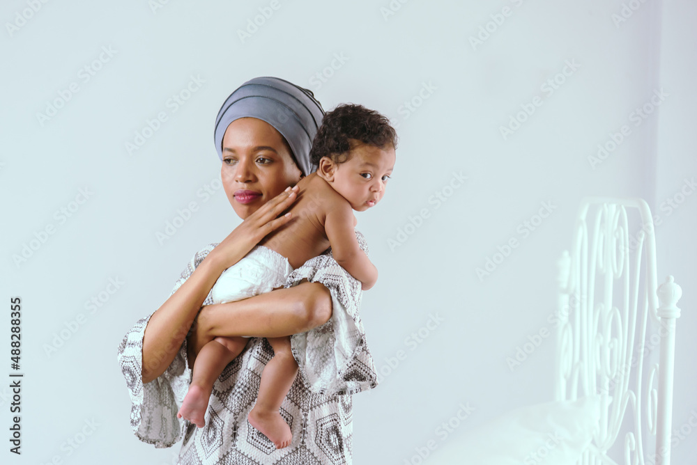 African mother raising a happy baby in the house Stock 写真 | Adobe Stock