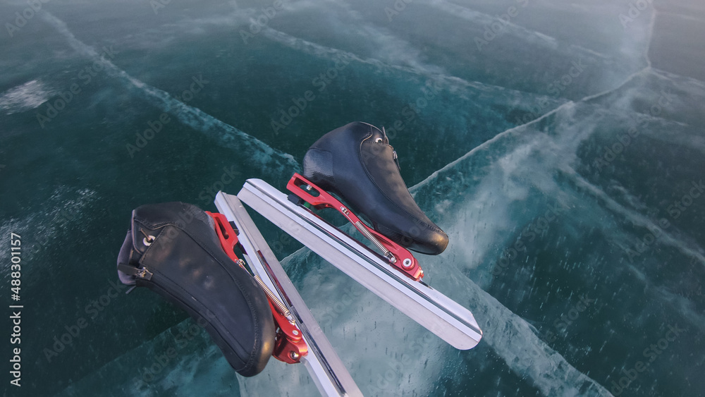 The skates boots are on the ice. The child train on ice speed skating ...