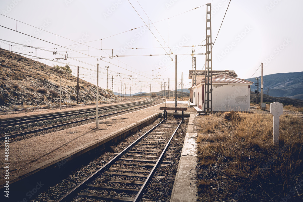 electrified railroad tracks with a curve in the background, in front of ...