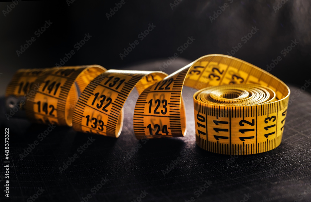 Centimeter of yellow color on a dark background. Length measuring tool ...