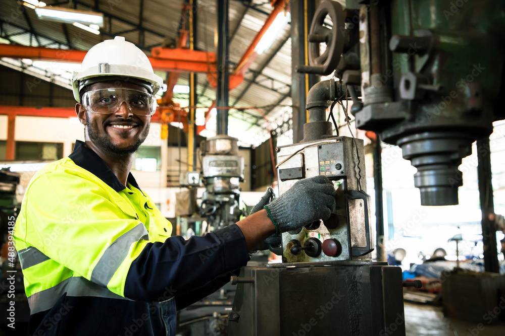 Africa American worker with lathe Machine and wearing safety goggles ...