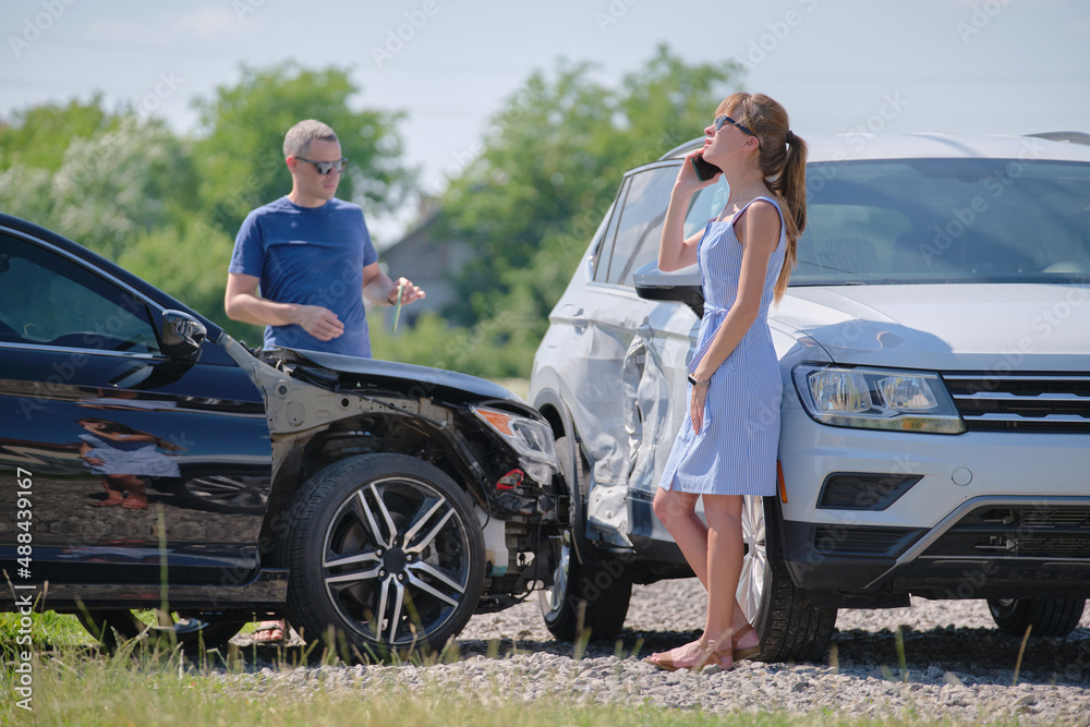 Angry woman and man drivers of heavily damaged vehicles calling ...