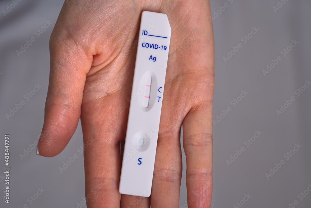 Woman hand holding rapid covid antigen test or express covid test with ...