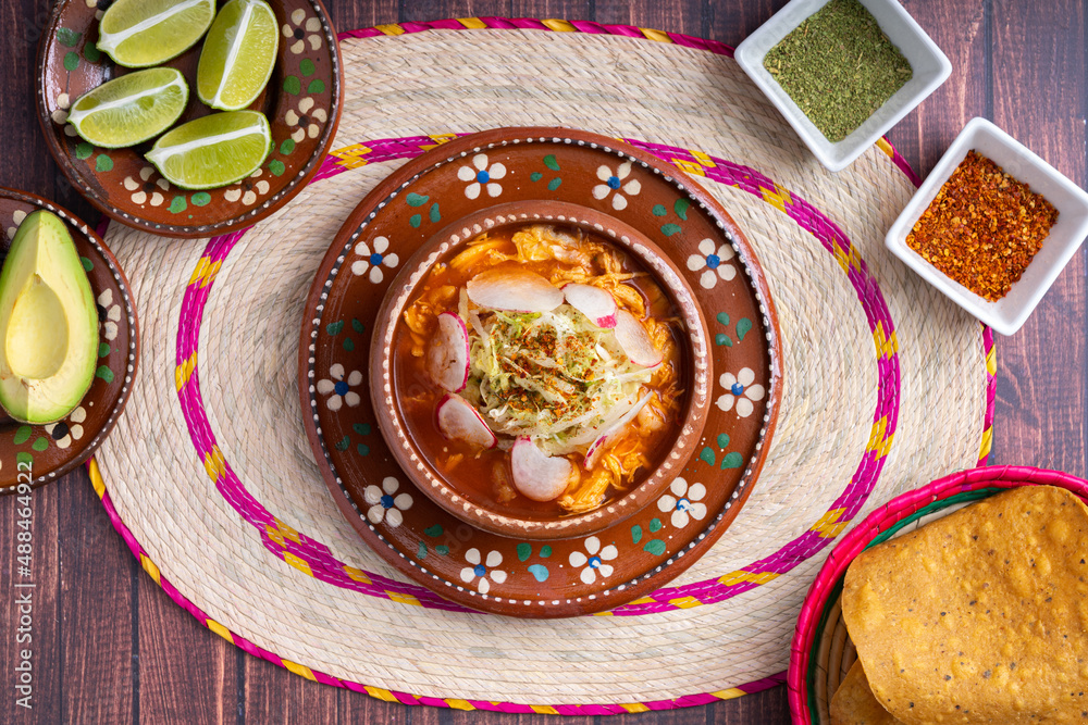 Traditional mexican food. Red pozole soup with chicken accompanied with ...