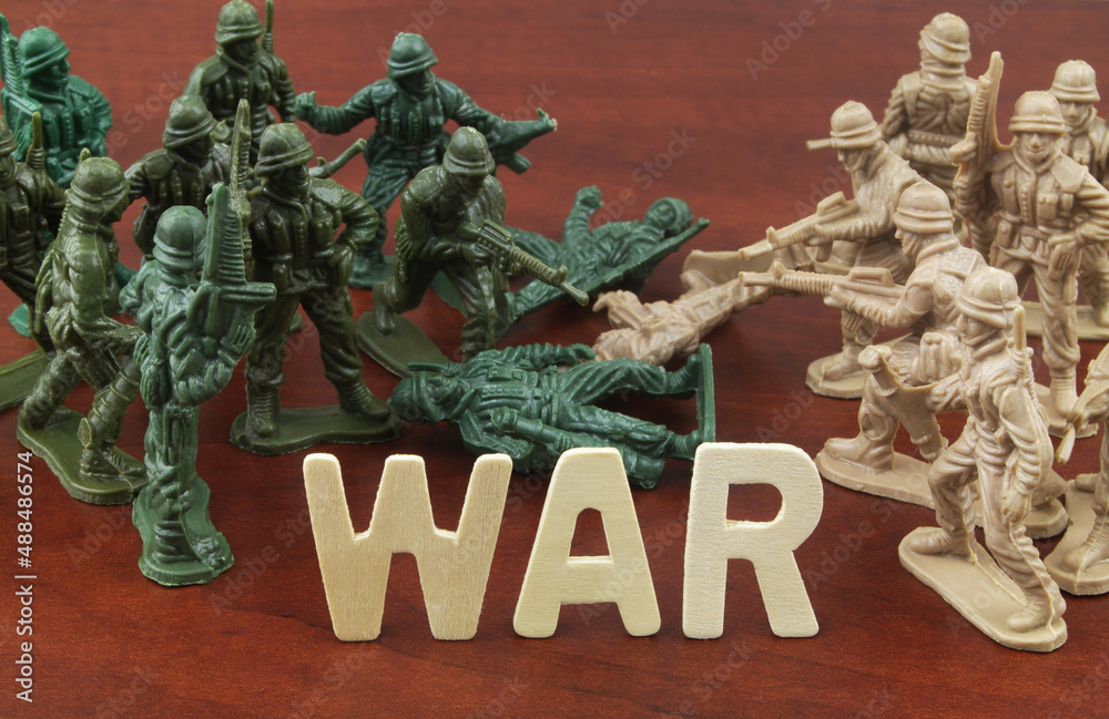 War conflict concept. Two groups of toy soldiers attack each other with ...
