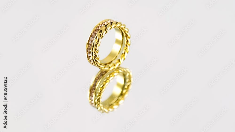 Rotating golden knotted sparkly twin golden ring with zircons and its ...
