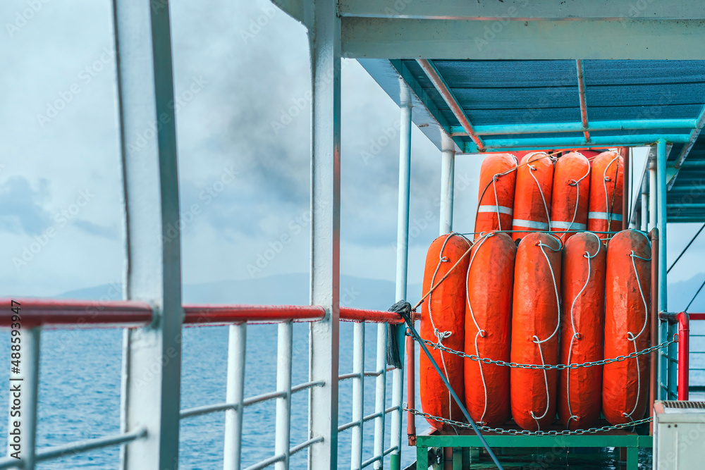Orange inflatable lifeboats on ferry deck for emergencies and maritime ...