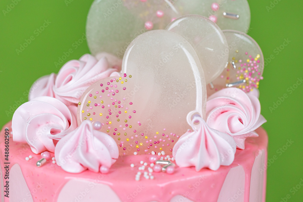 Pink cream cheese cake with chocolate chip gouges decorated with ...