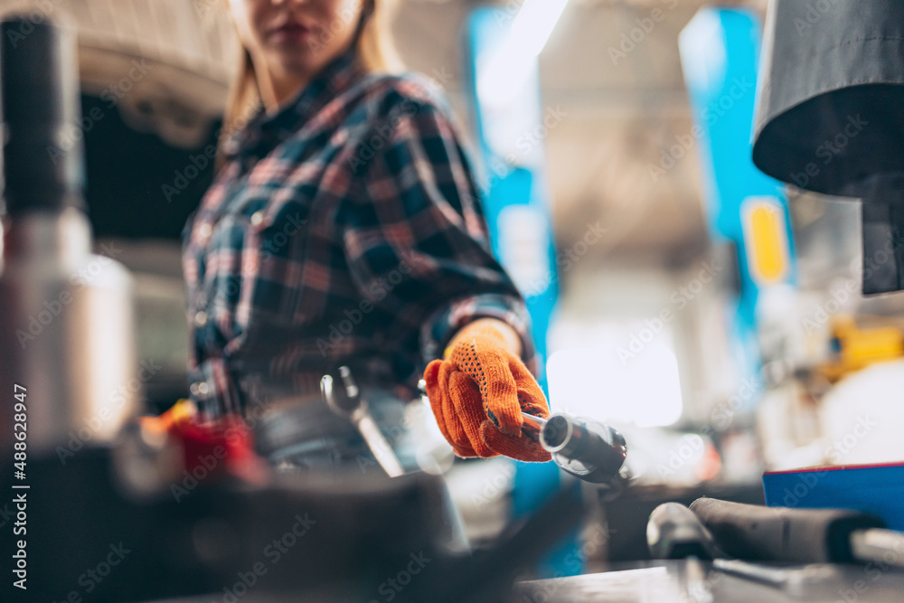 Female auto mechanic. beautiful young red-headed girl in working ...