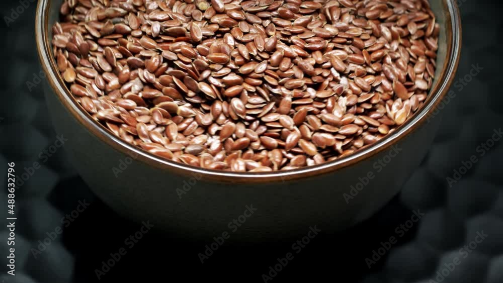 Flaxseed in bowl. Close-up view of linseed, zoom-in, table spin. Stock ...
