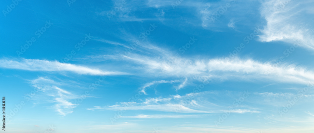 Poster Sparse translucent cirrus clouds high in the clear blue sky ...