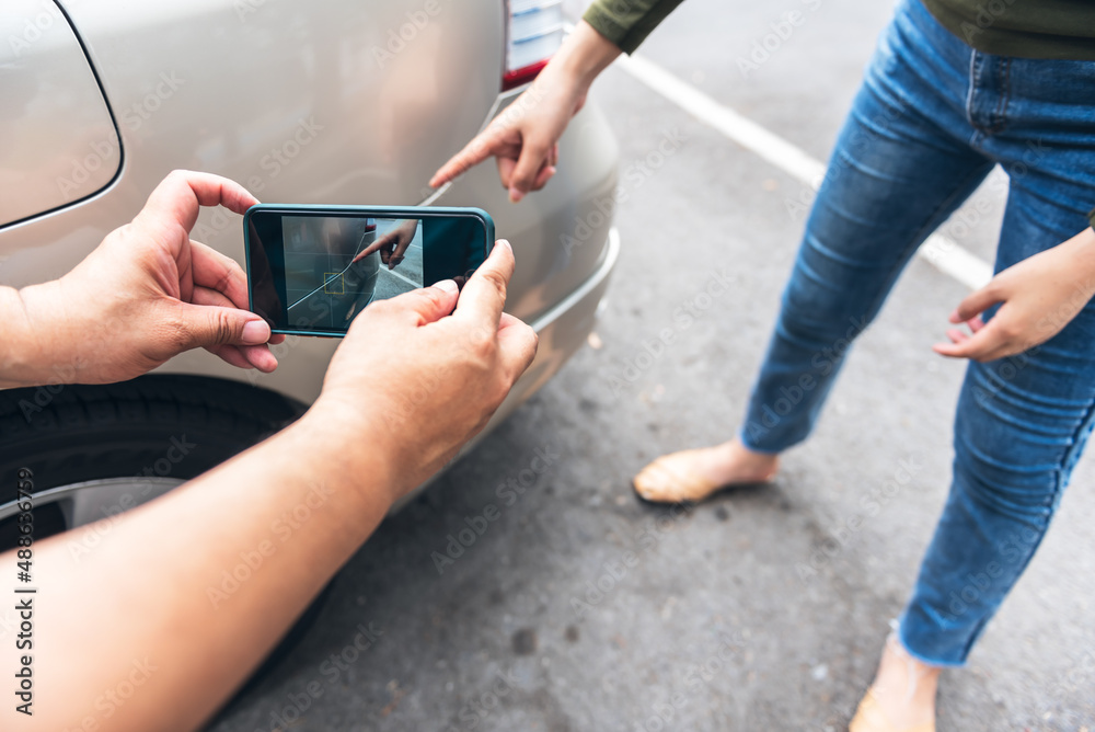 People using a mobile phone Take photos of the damage of the car, Which ...
