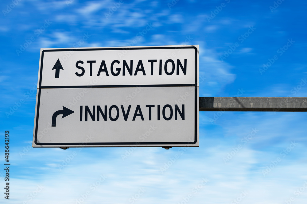 Road sign with words stagnation and innovation. White two street signs ... Road sign with words stagnation and innovation. White two street signs ...