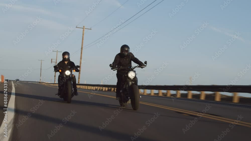 Motion wallpaper of motorcyclists riding along a highway with the ocean ...