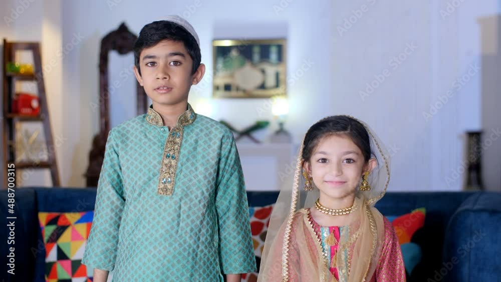 A young Muslim brother-sister doing a Salaam-Alaikum gesture - hello by ...