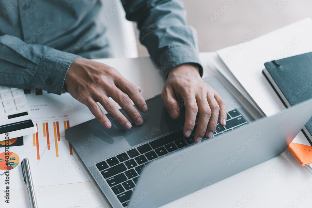 Businessman's hand presses on a laptop keyboard, World of technology ...