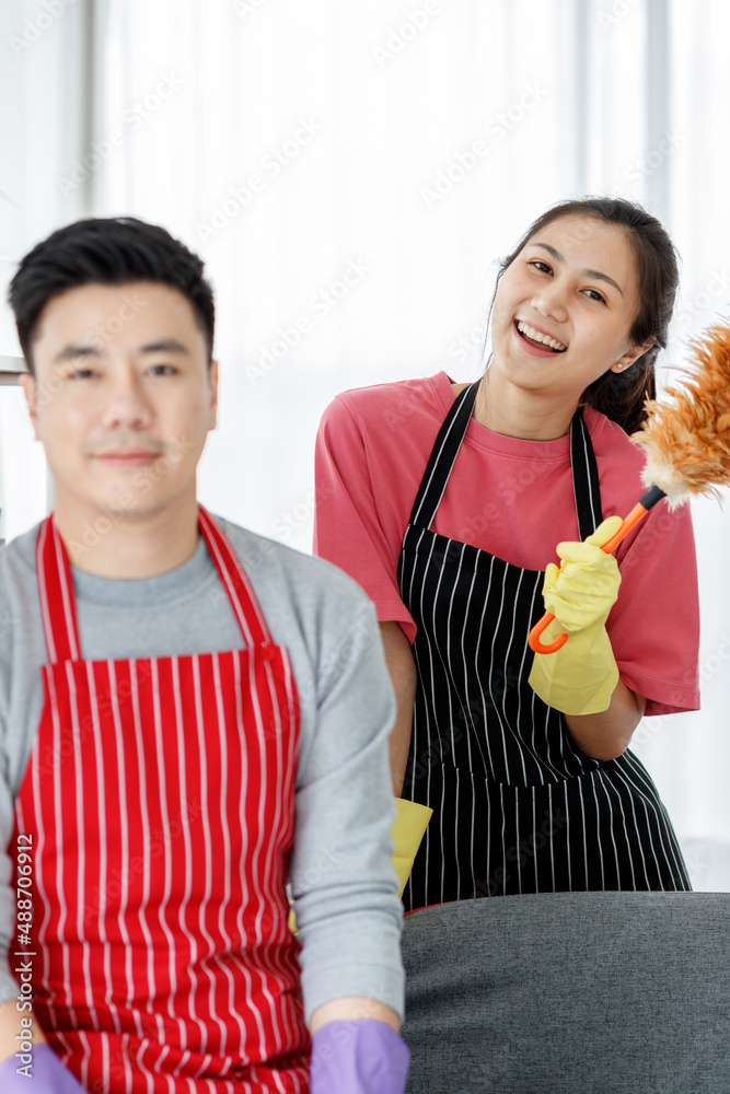 Portrait shot of Asian happy male husband housekeeper servant in maid ...