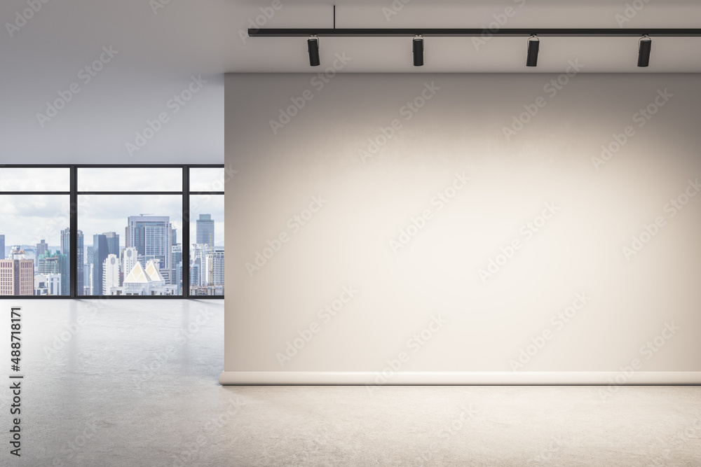 Blank white wall with copyspace for your logo illuminated by spotlights ...