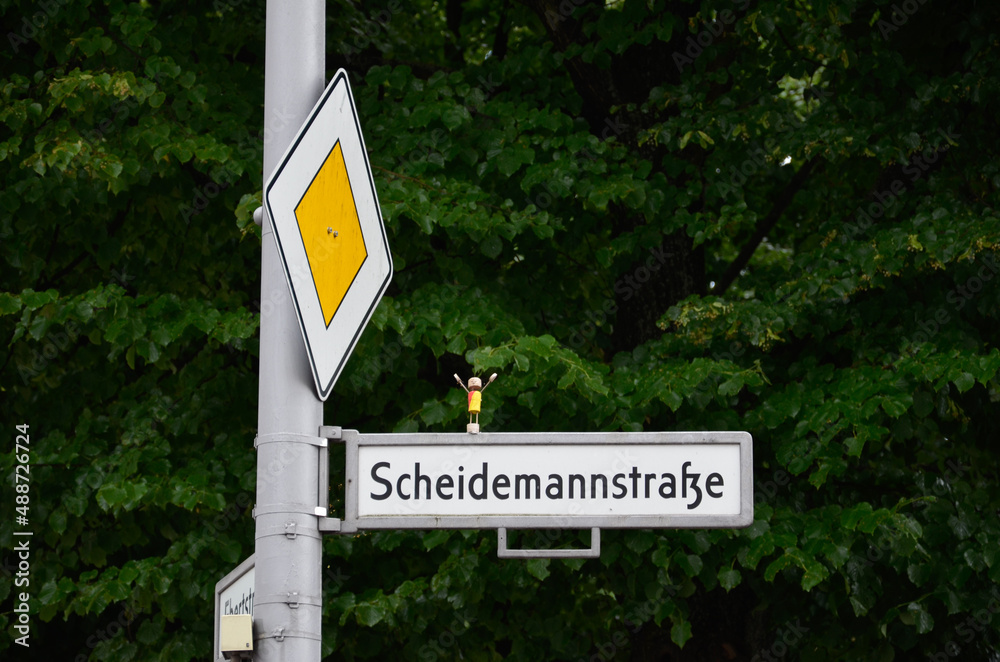 Berlin street sign of Scheidemannstraße with small cork man on it and a ...