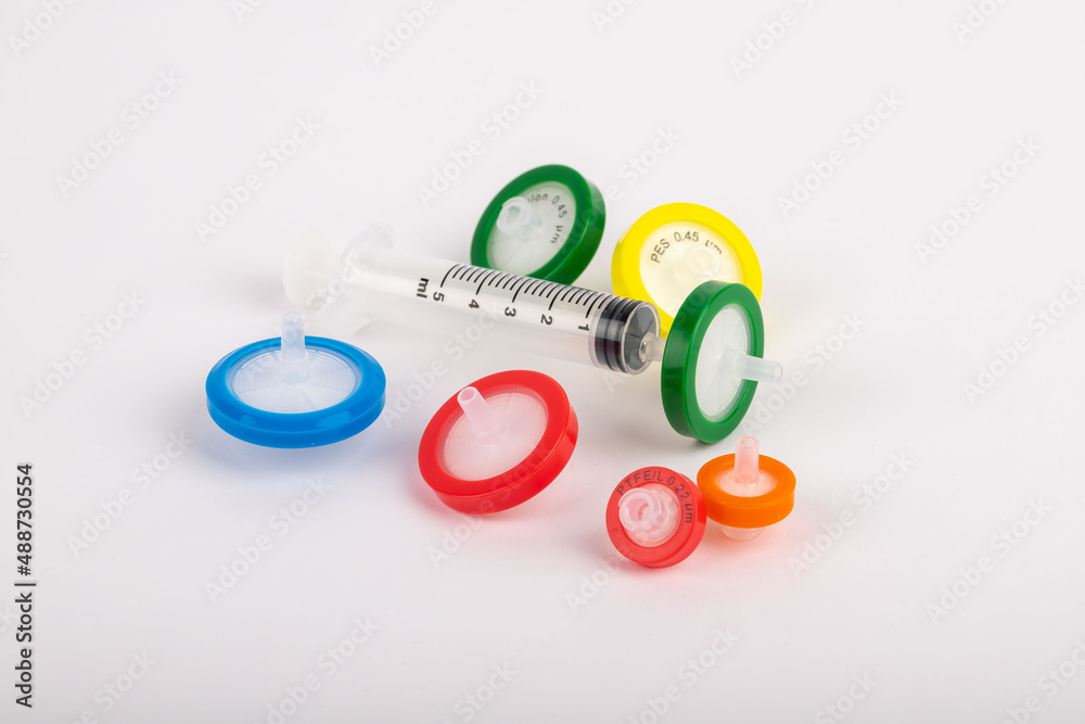 Colorful needlepoint filters standing on a white background. They are ...