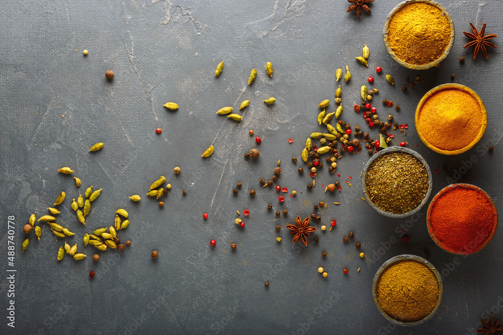 Wooden table of colorful spices. Dark.background. Stock Photo | Adobe Stock