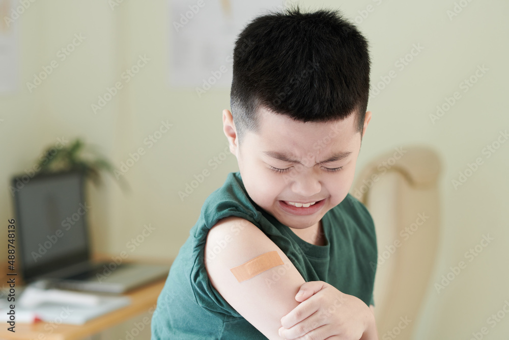 Asian little boy crying after getting an injection he sitting at ...
