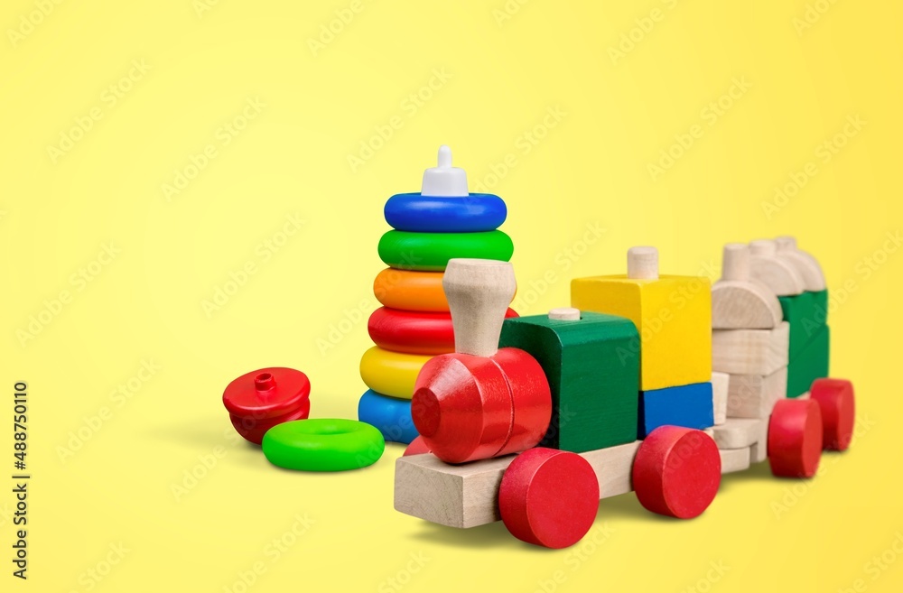 Baby kids toys background. Wooden toy train, wood stacking pyramid ...