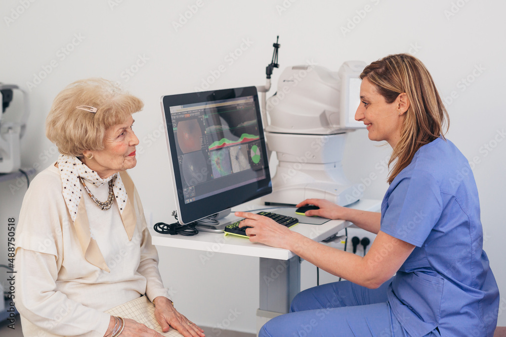 older woman has eye examination. digital retina scanner Stock Photo ...