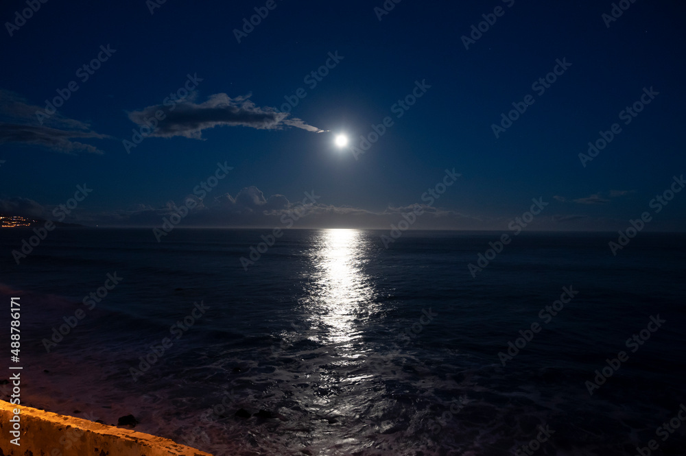 Moonlight path on water of Atlantic ocean at night on Tenerife and dark ...