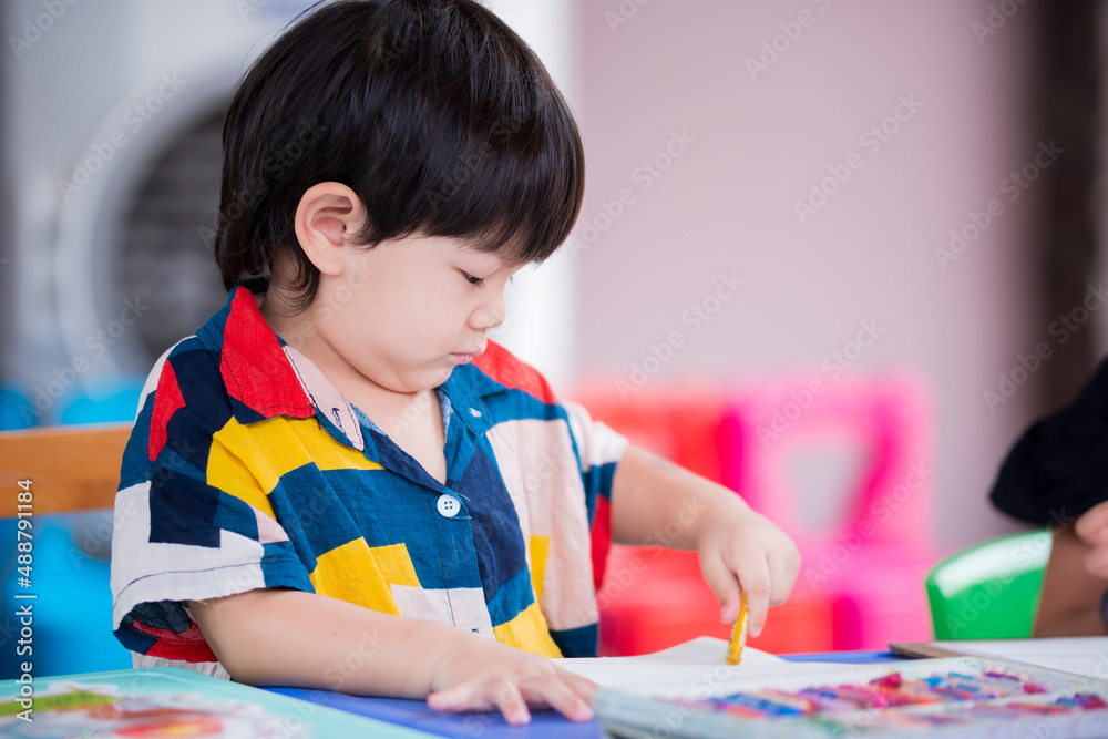 Baby boy is making art painting with crayons. Preschoolers are learning ...