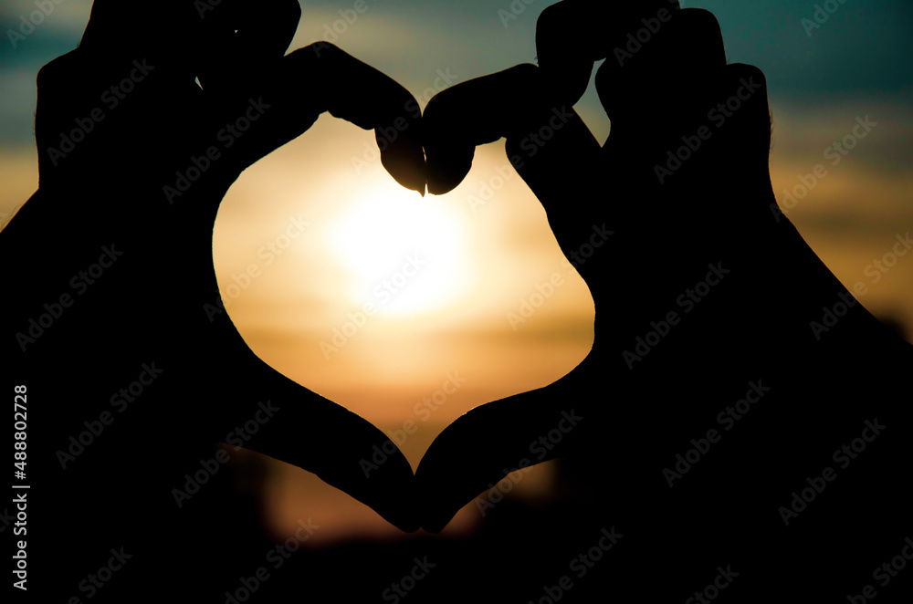 Silhouette of a girl hands with heart shaped love. Heart shape made ...