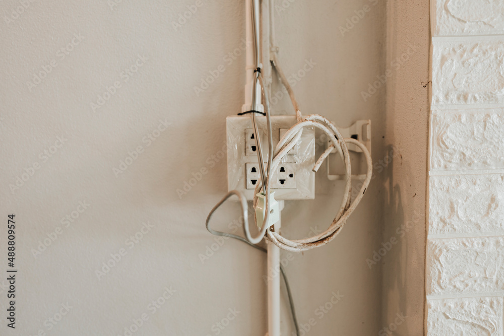 Unsafe power outlets and wiring Safety concept on the building's wall ...