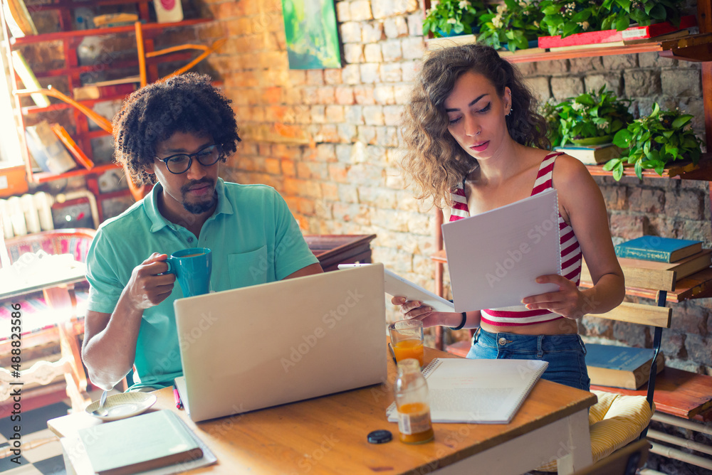Woman and man students studying in the coffee shop using laptop. Stock ...