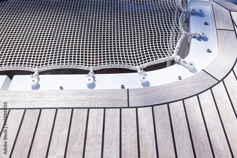 Part of a stretched white net with ropes threaded into loops on the ...
