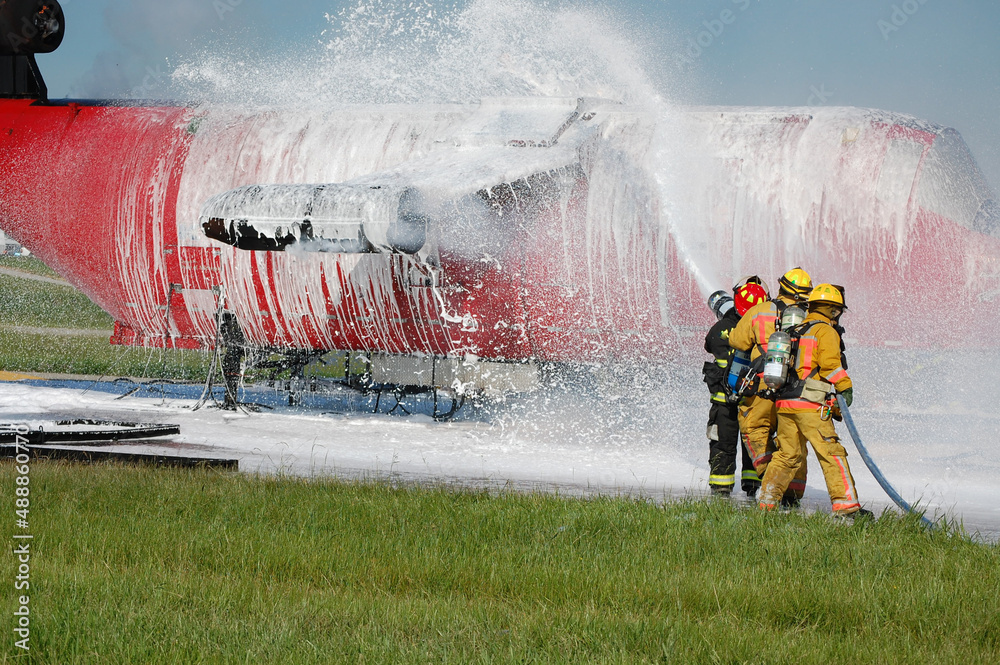 Team of firefighters spraying foam during aircraft training Stock Photo ...
