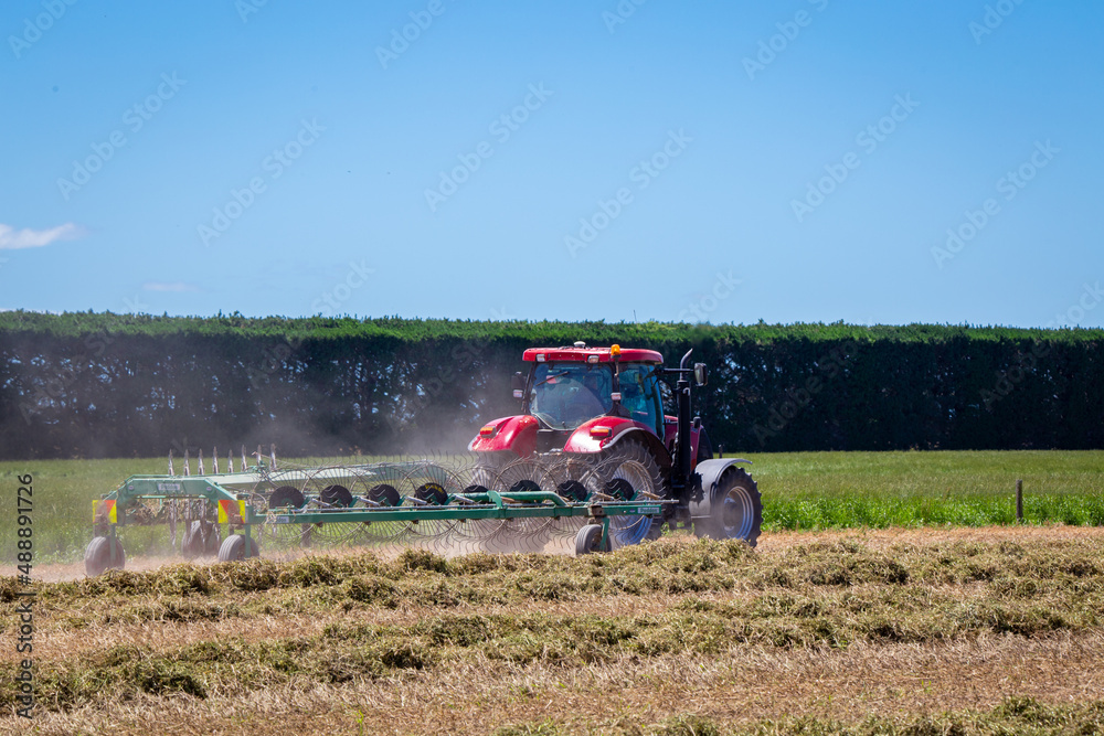 Canterbury, New Zealand, 26 December 2021: A Case tractor pulls a hay ...