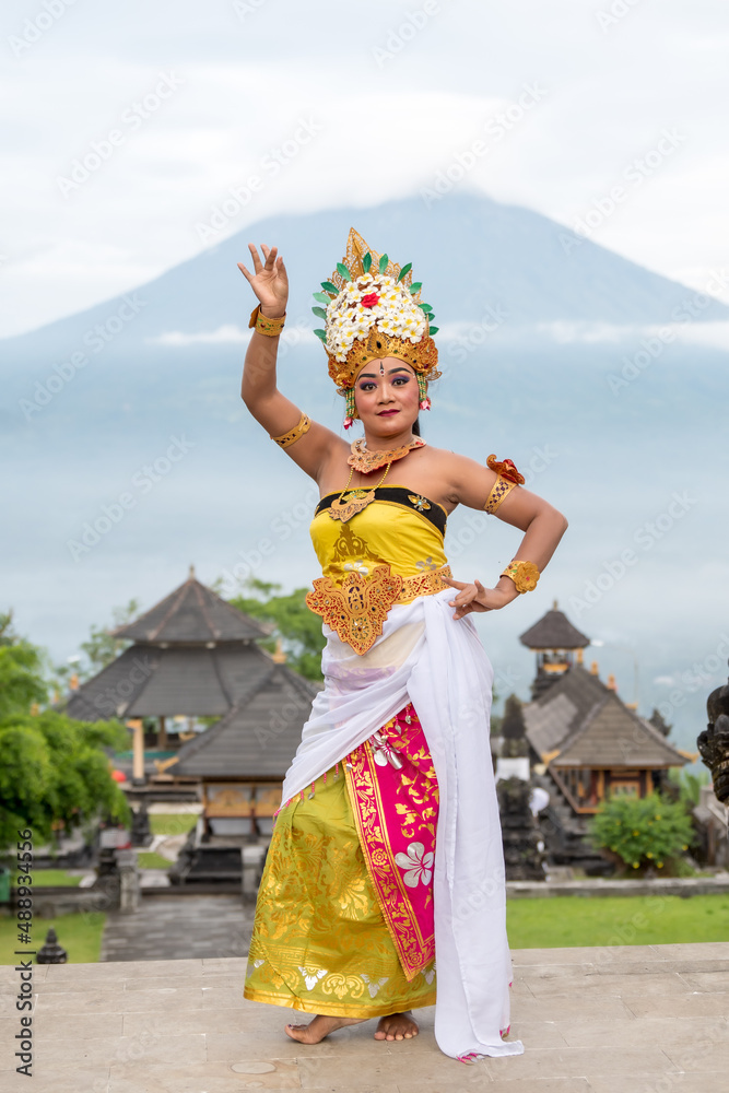 Portrait of beautiful young balinese woman dancer wearing a traditional ...