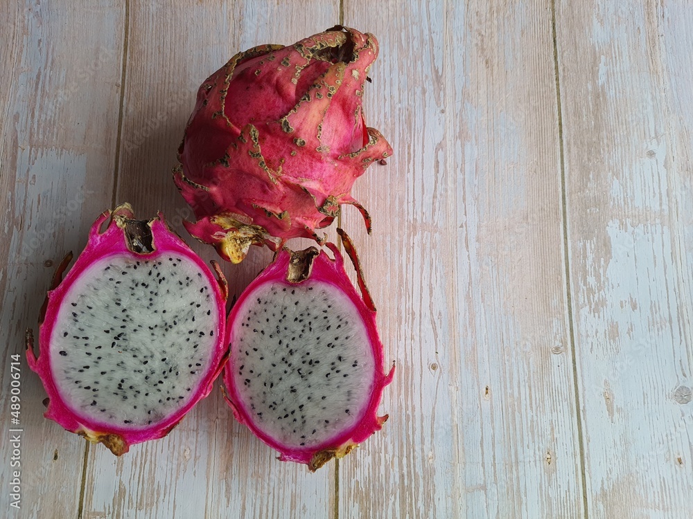 The pitaya or dragon fruit or jelly fruit, white, cut in half, top view ...