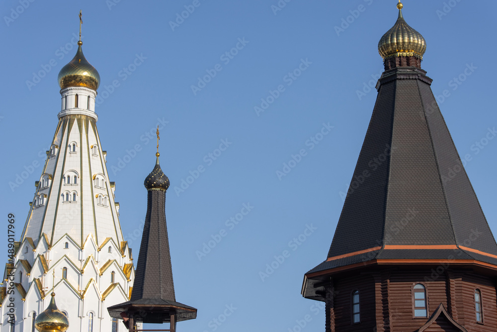 High conical roofs of a Christian Orthodox church with gilded domes and ...