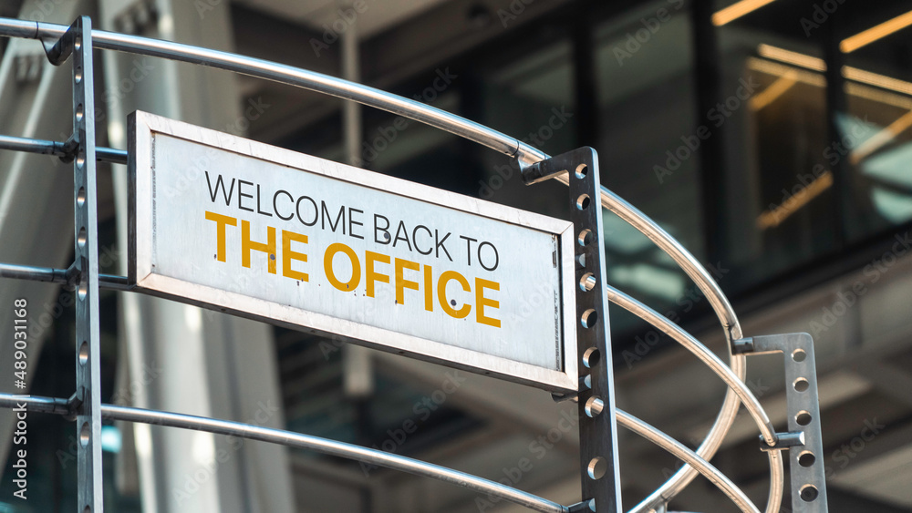Welcome back to the Office Sign in front of large city center office ...