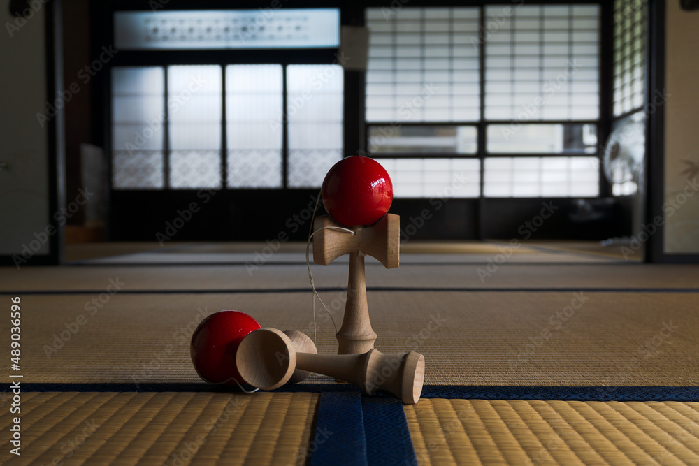 Kendama, a traditional Japanese game, displayed on a tatami floor in a ...