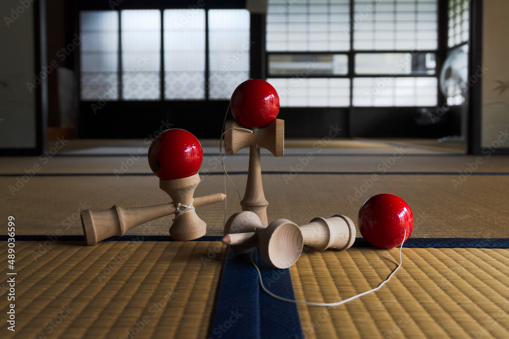 Kendama, a traditional Japanese game, displayed on a tatami floor in a ...