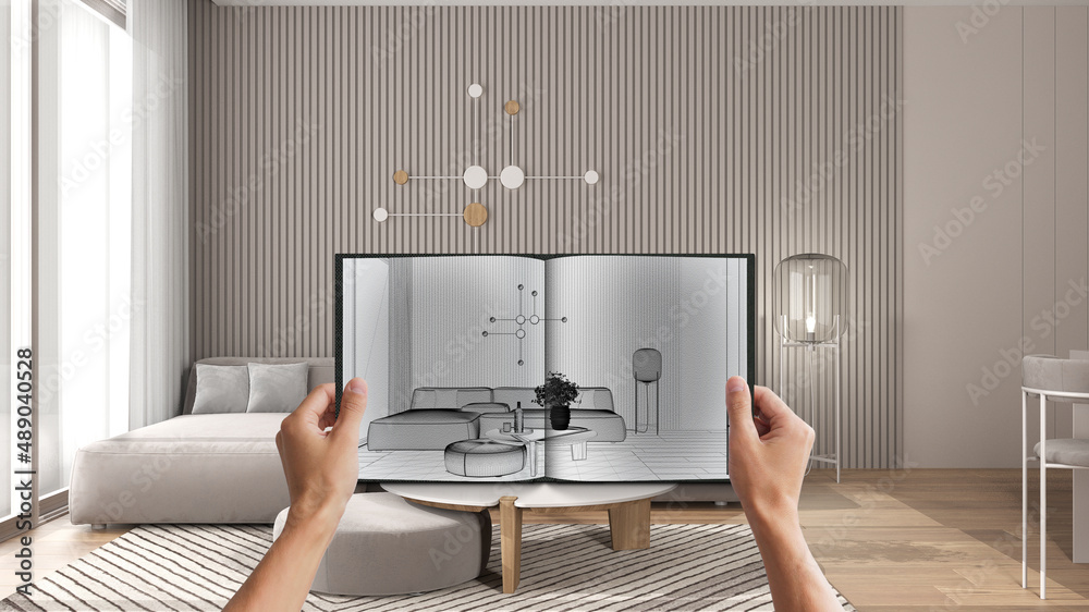 Hands holding notepad with modern living room design blueprint sketch ...