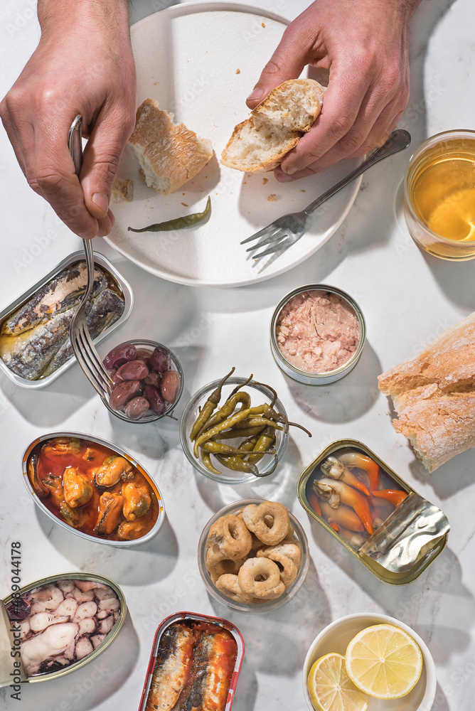 Foto de Male luxury dinner with various delicious canned fish and ...